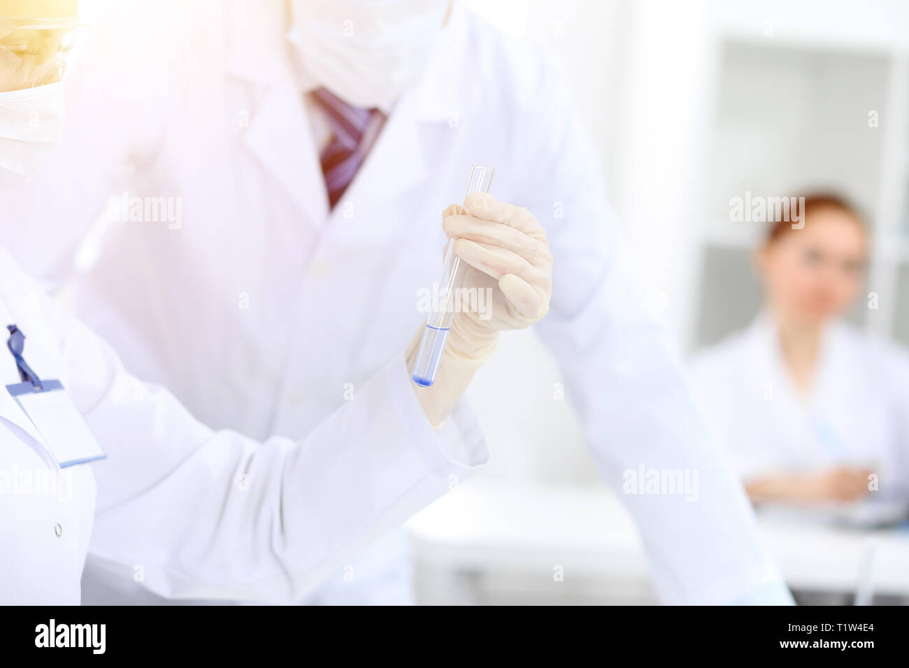 Scientific research team with clear solution in laboratory Stock Photo ...