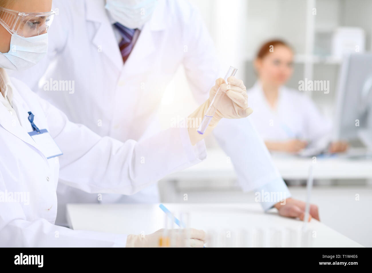 Scientific research team with clear solution in laboratory Stock Photo ...