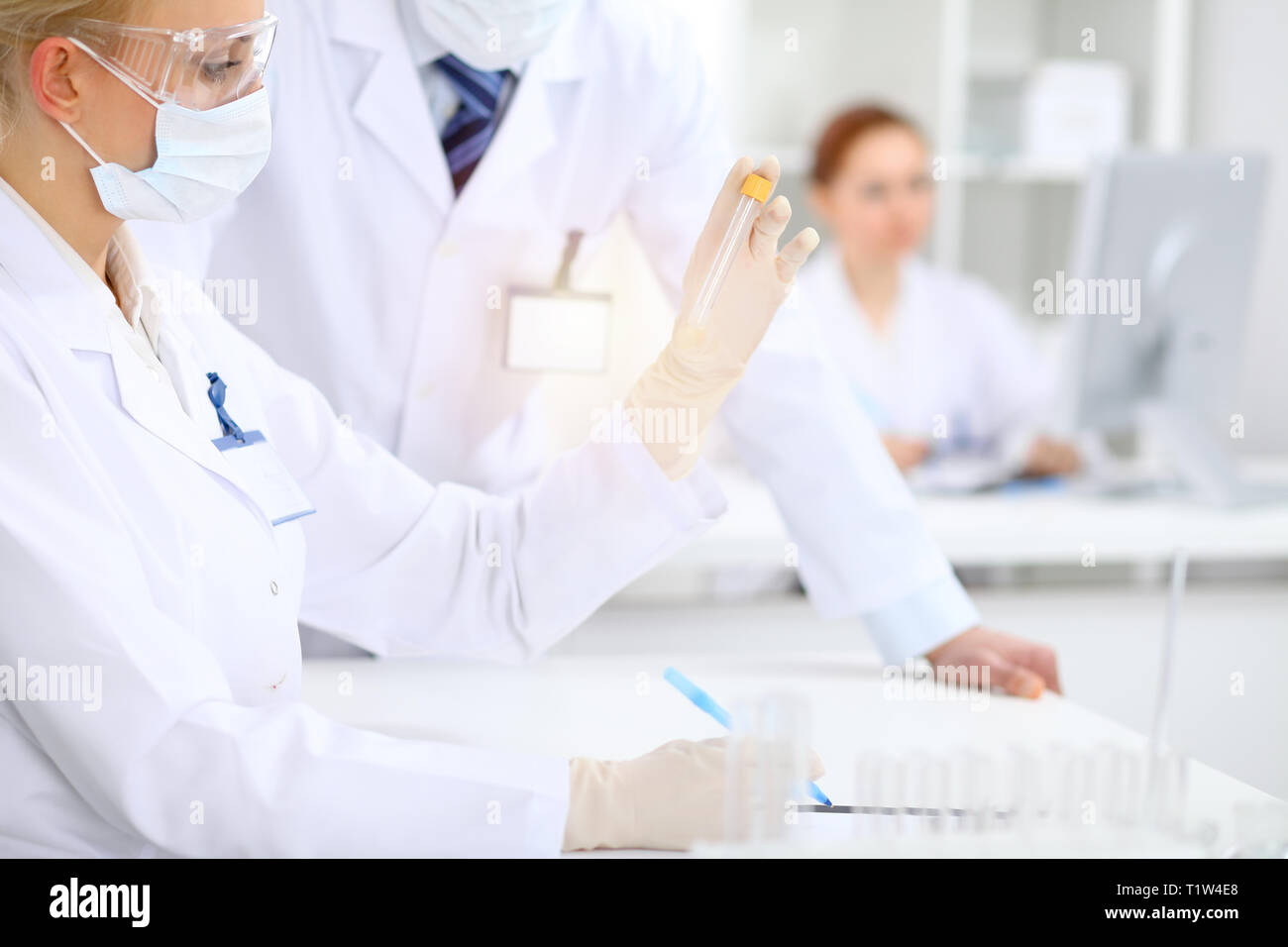 Scientific research team with clear solution in laboratory Stock Photo ...