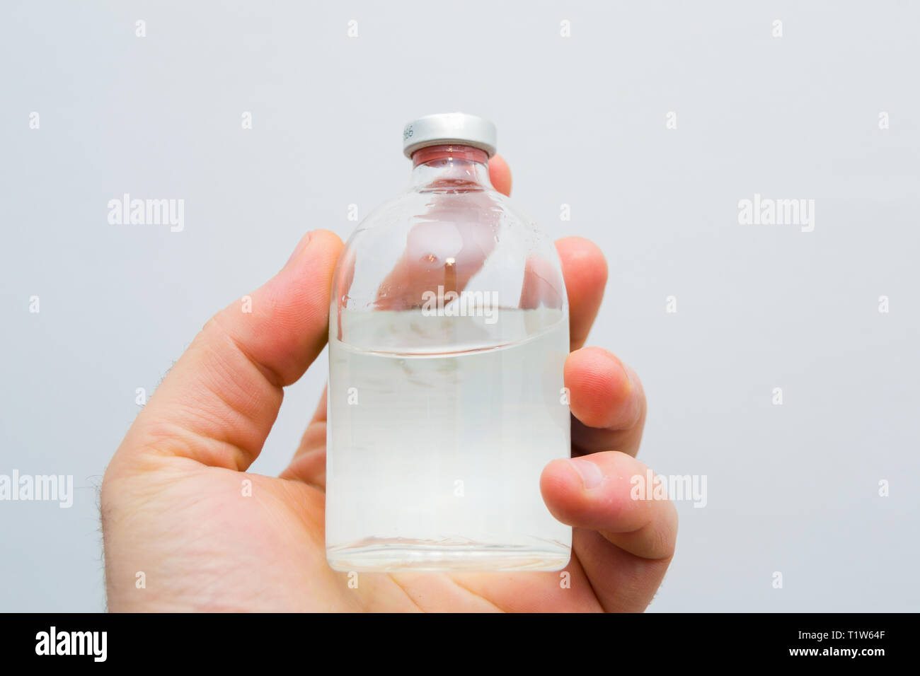 vial with transparent drug solution in a man's hand Stock Photo - Alamy