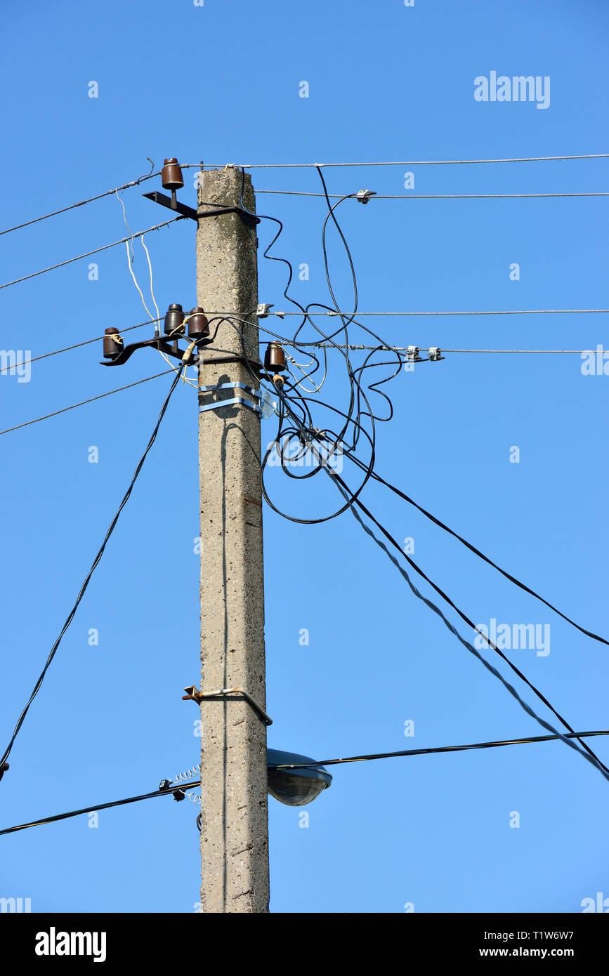 Close-up upper part of utility pole with many electric wires and ...