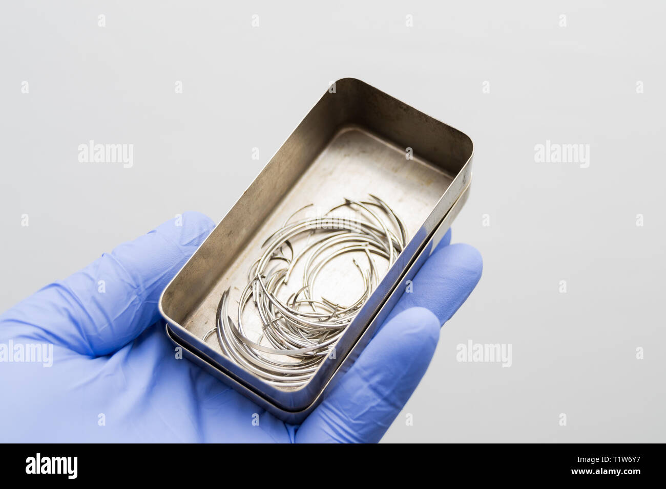 surgical needles in the metal box in the hand of surgeon Stock Photo ...