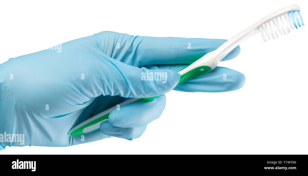 Toothbrush in the gloved hand Stock Photo - Alamy