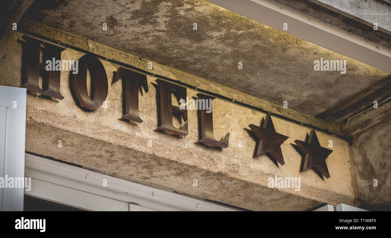 hotel sign on a stone wall with two stars in France Stock Photo - Alamy