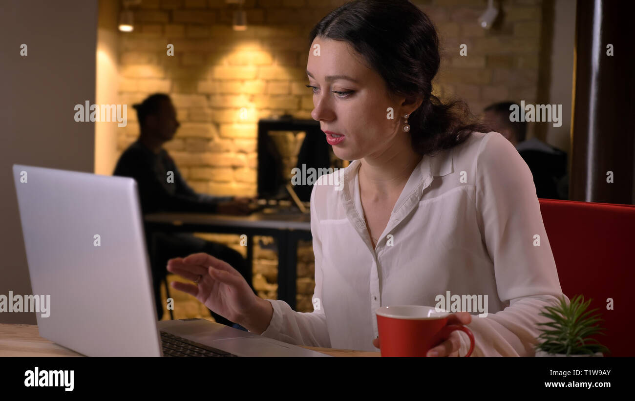 Closeup shoot of young shocked caucasian businesswoman typing on the ...