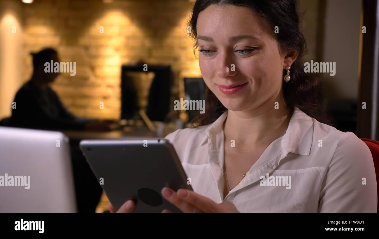 Closeup shoot of young pretty caucasian female office worker using the ...