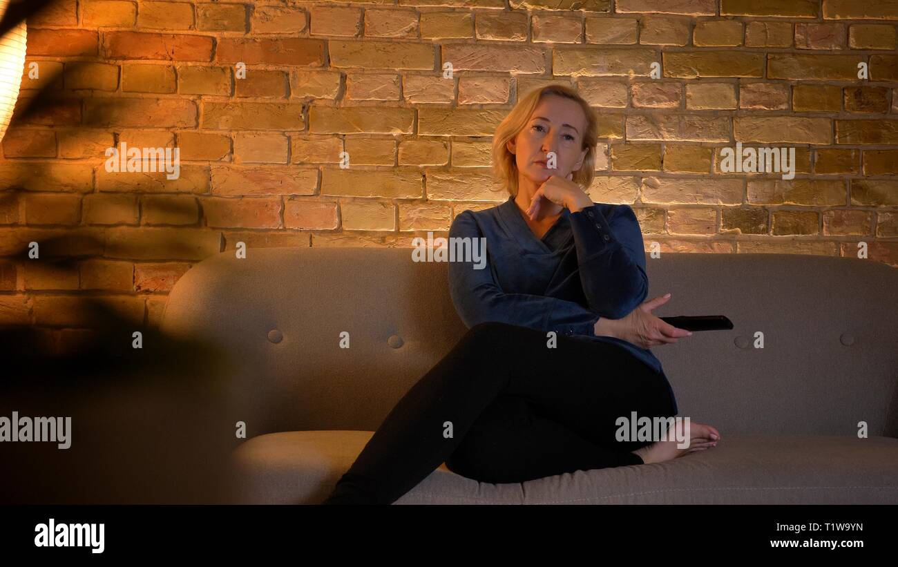 Old lady watching tv on sofa hi-res stock photography and images - Alamy