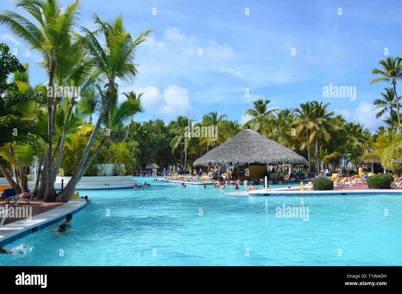 Beautiful luxury swimming pool at a tropical resort, People relax at ...