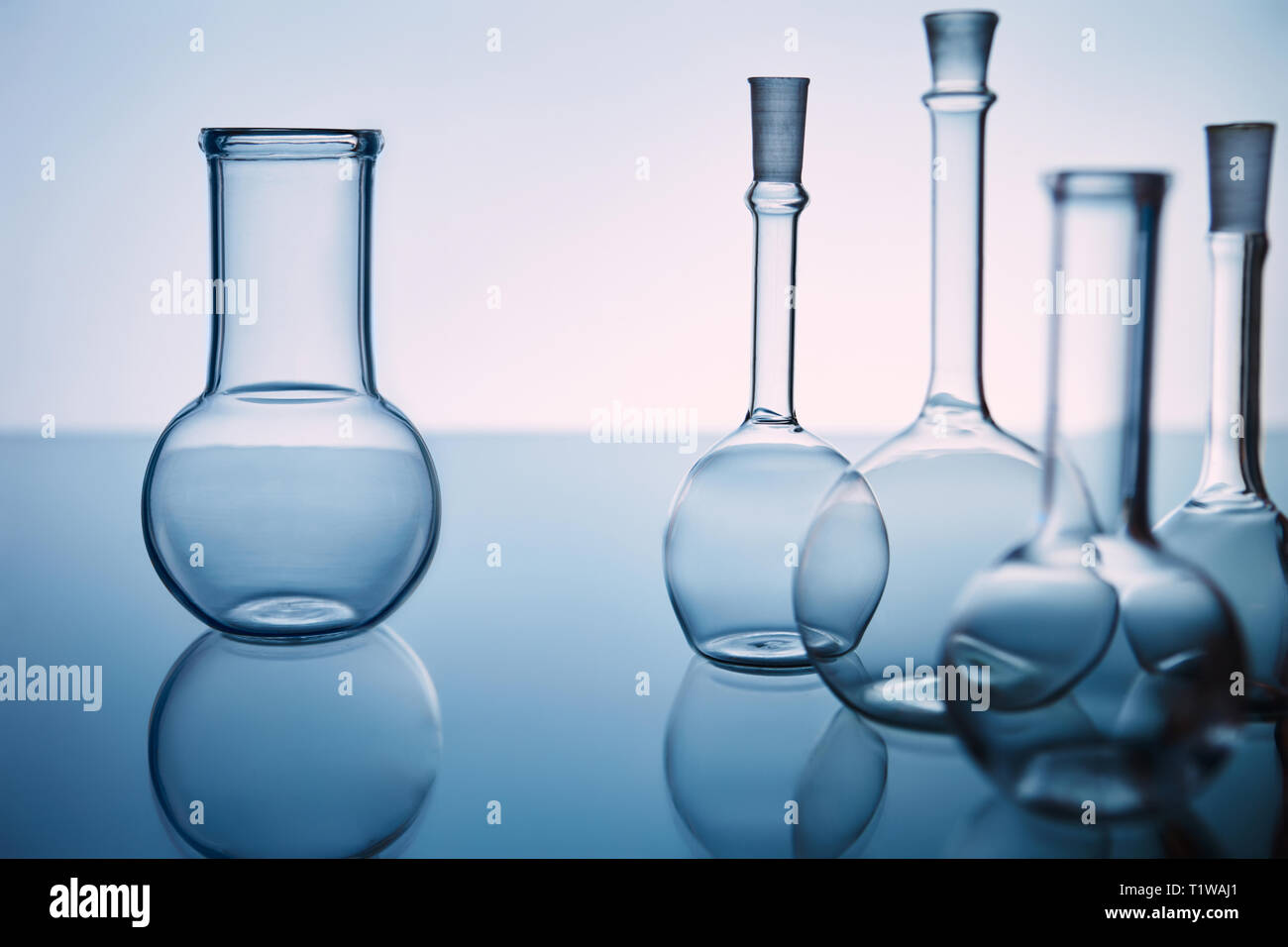 many beakers in the backlight, reflection, blue background Stock Photo ...