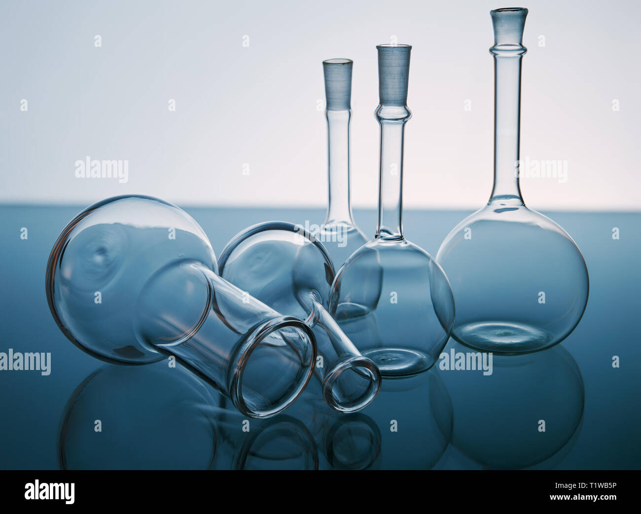 many beakers in the backlight, reflection, blue background Stock Photo ...
