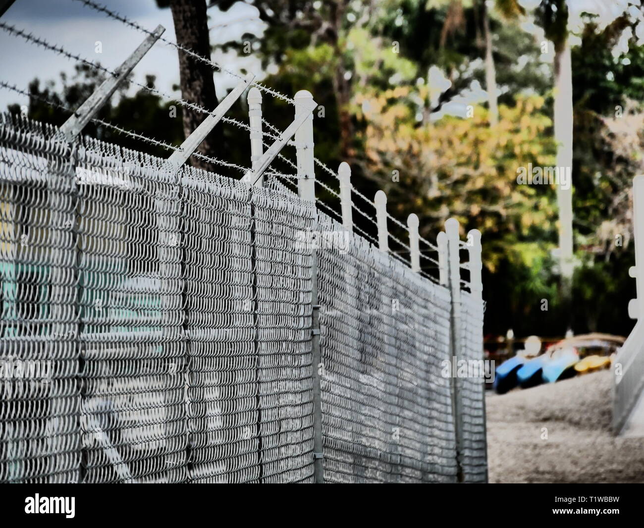 Wire fence around jail Stock Photo - Alamy