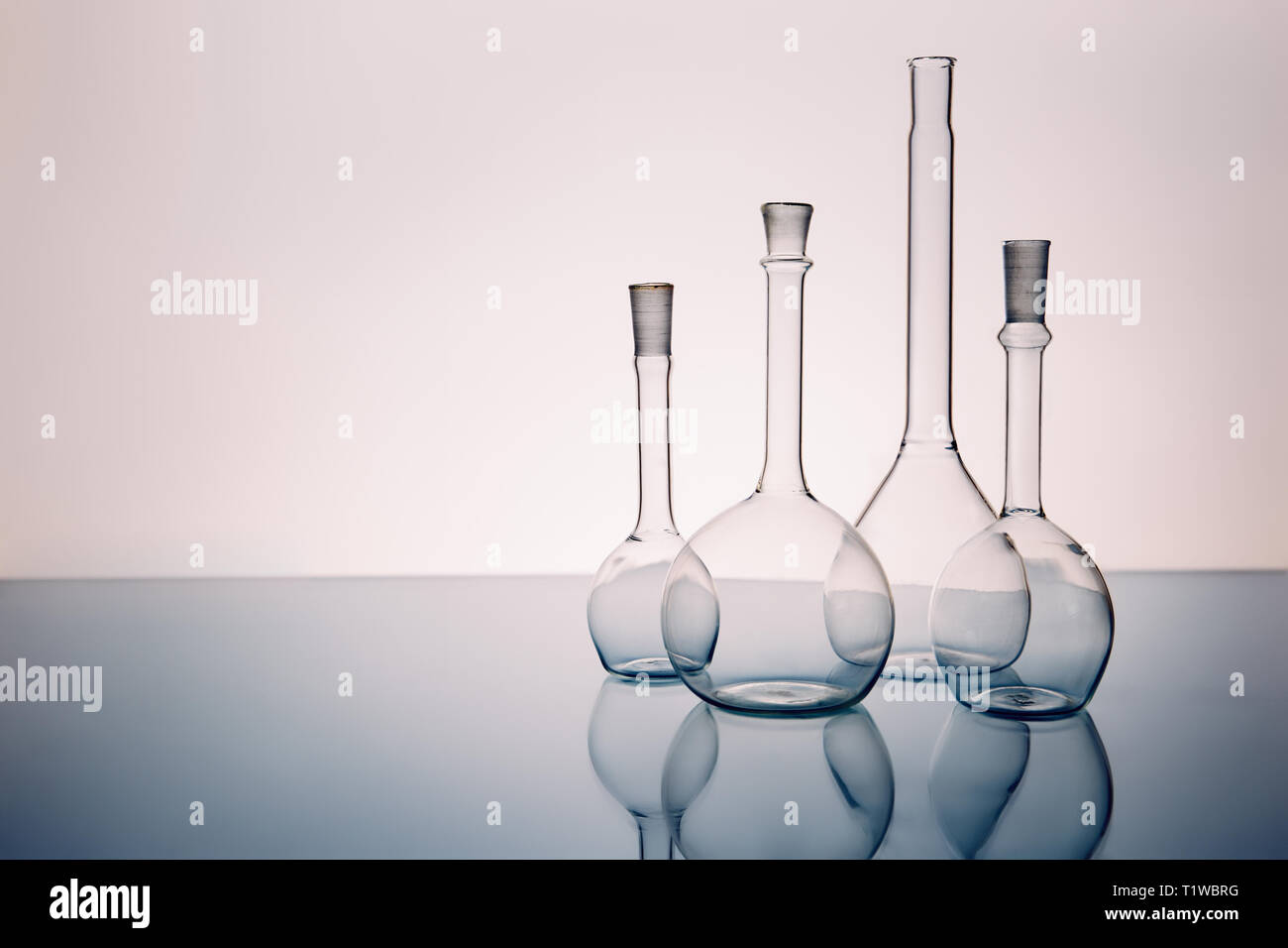 many beakers in the backlight, reflection, blue background Stock Photo ...