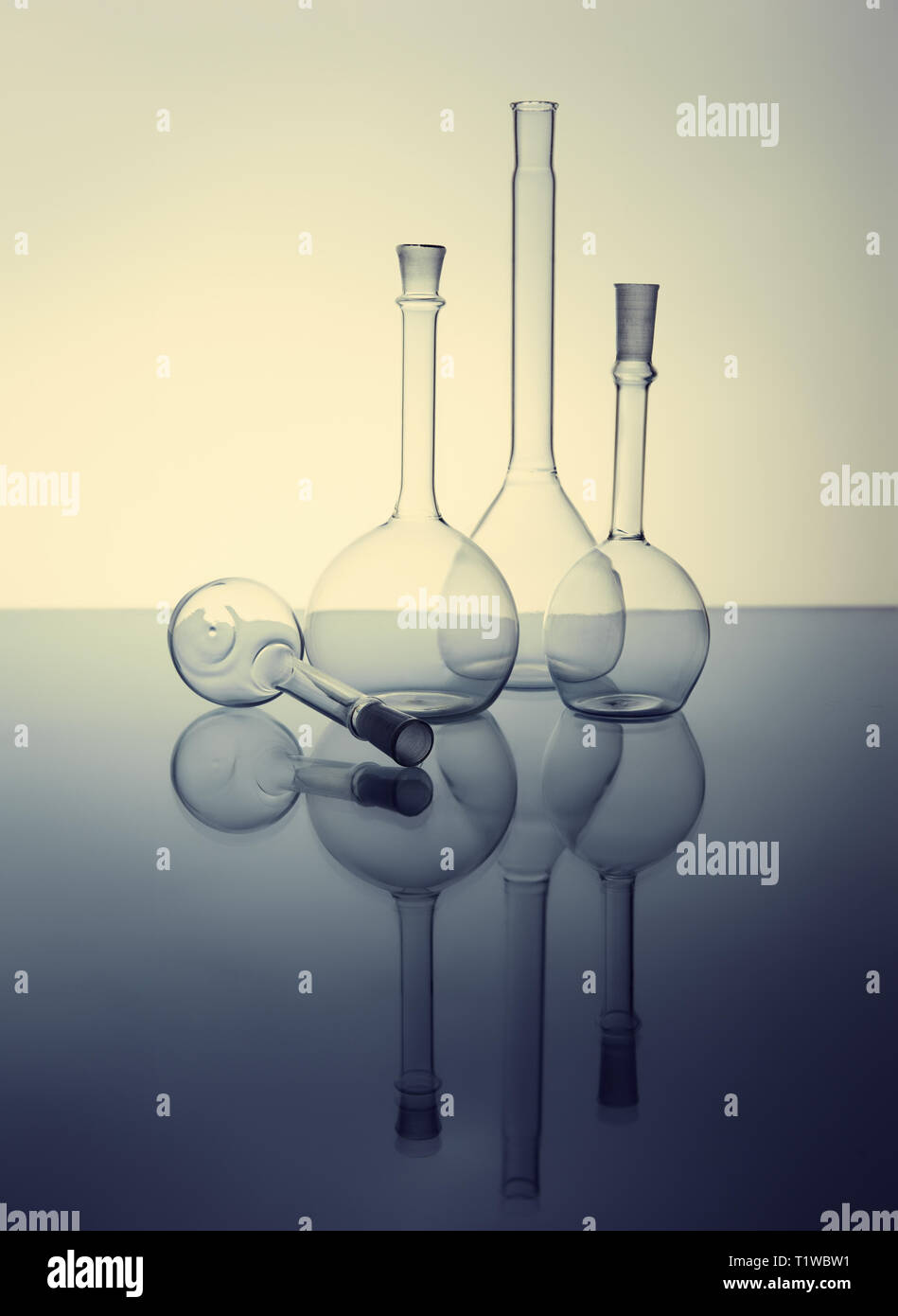 many beakers in the backlight, reflection, blue background Stock Photo ...