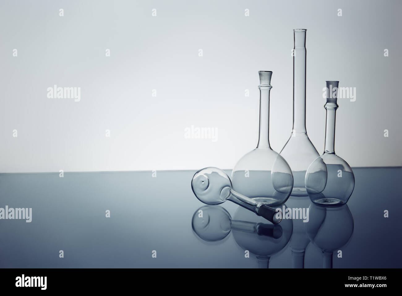 many beakers in the backlight, reflection, blue background Stock Photo ...