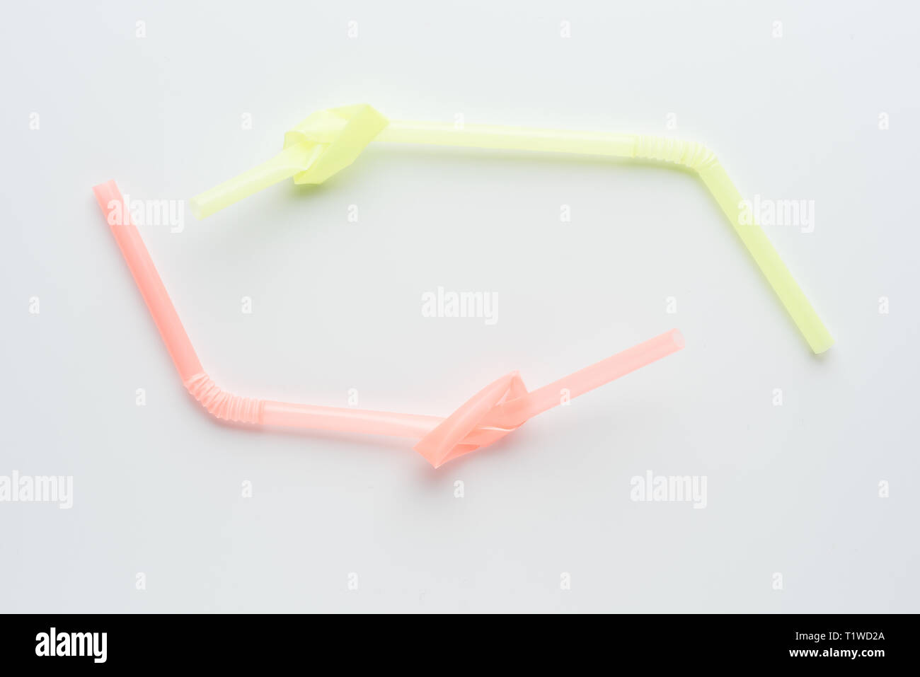 Disposable plastic knotted drinking straw. Conceptual photo about ...