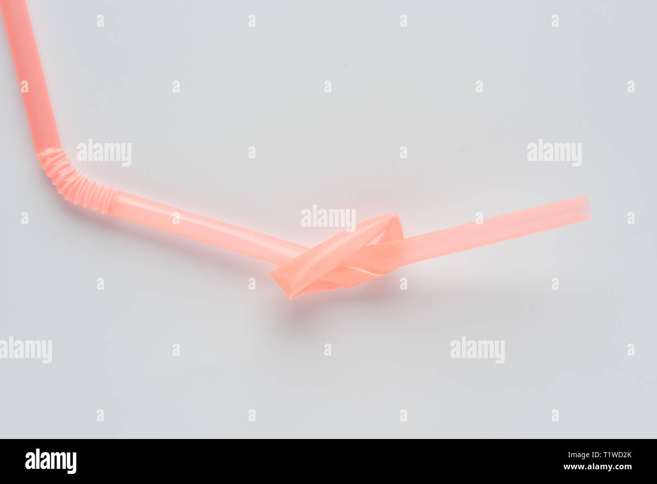 Disposable plastic knotted drinking straw. Conceptual photo about ...