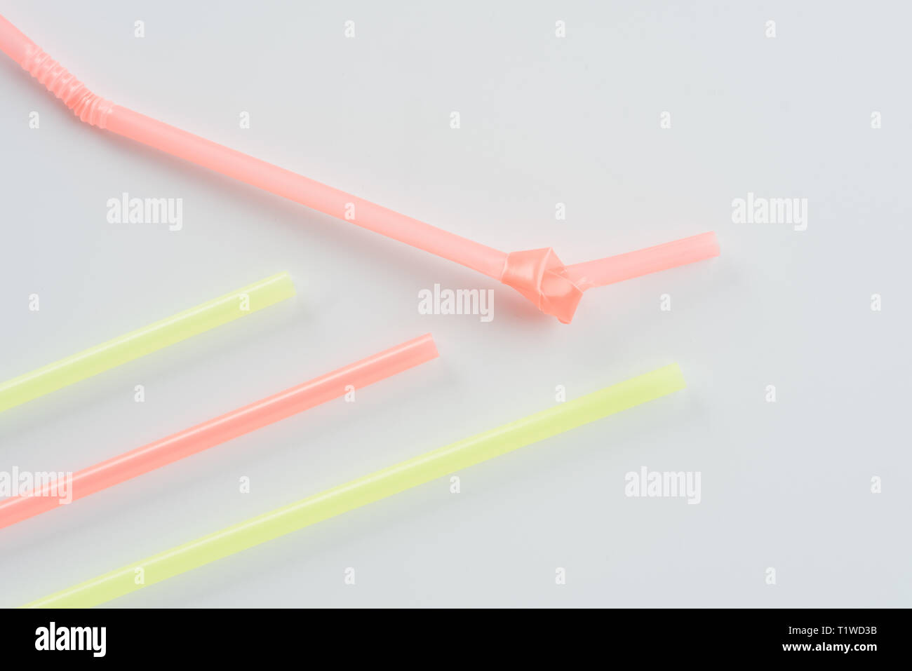 Disposable plastic knotted drinking straw. Conceptual photo about ...