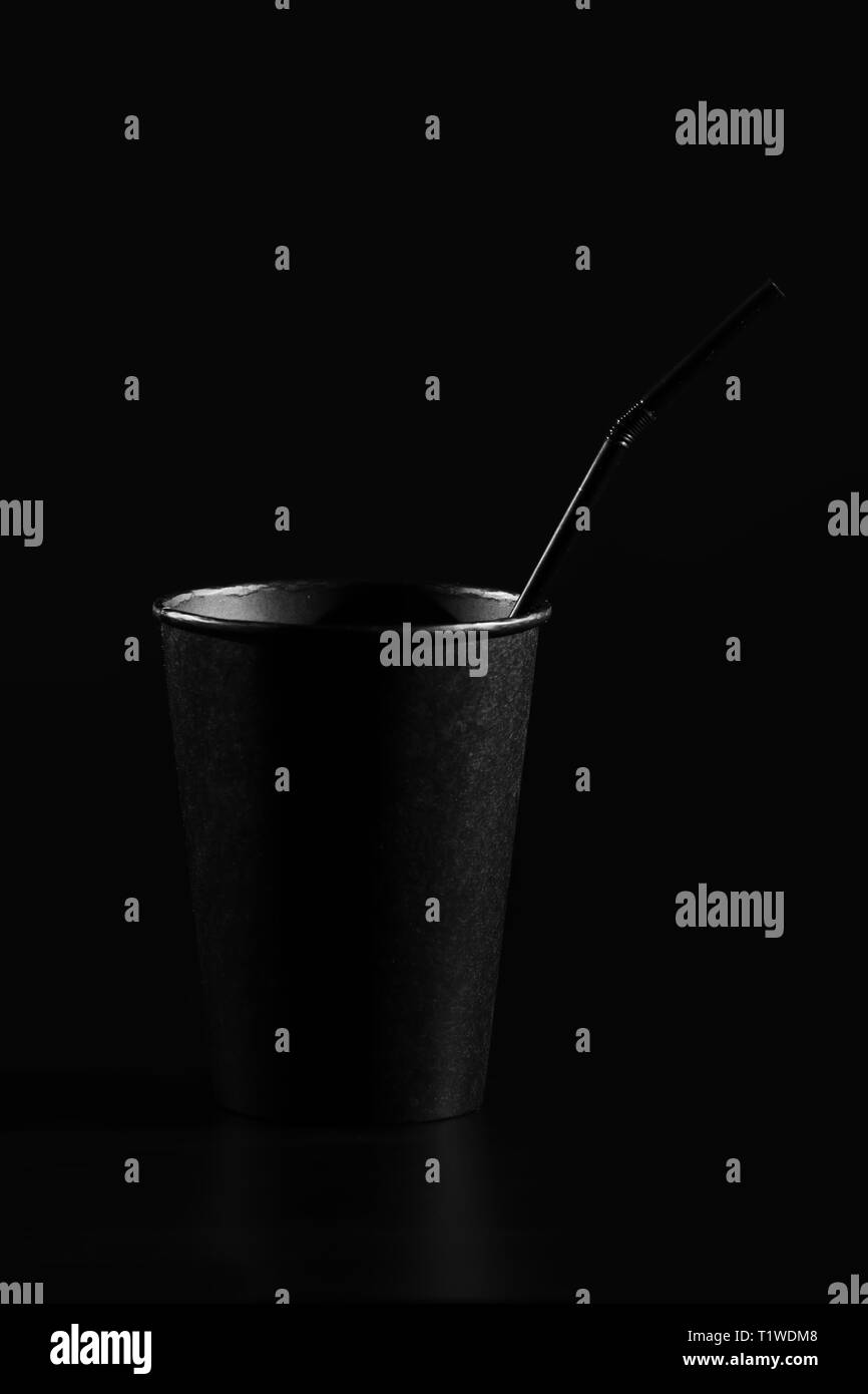 a glass of coffee or tea with a plastic cover. black paper glass with a ...