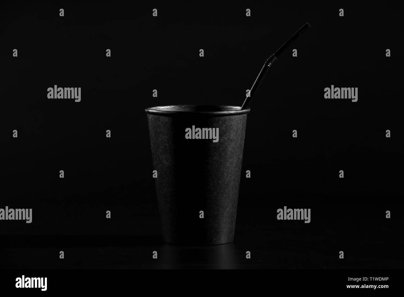 a glass of coffee or tea with a plastic cover. black paper glass with a ...