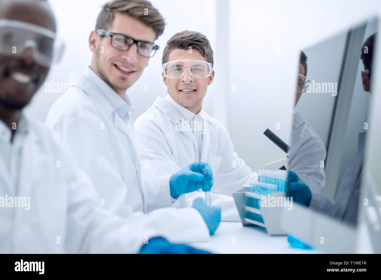 successful group of scientists sitting at their Desk Stock Photo - Alamy
