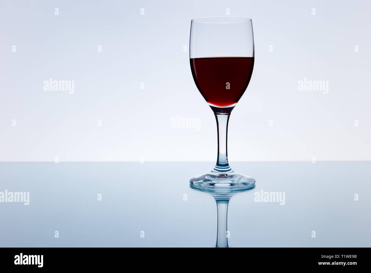wine glass a reflection on a light background, backlighting Stock Photo ...