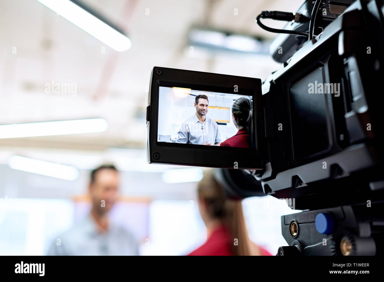 Happy businessman during corporate interview with female journalist ...