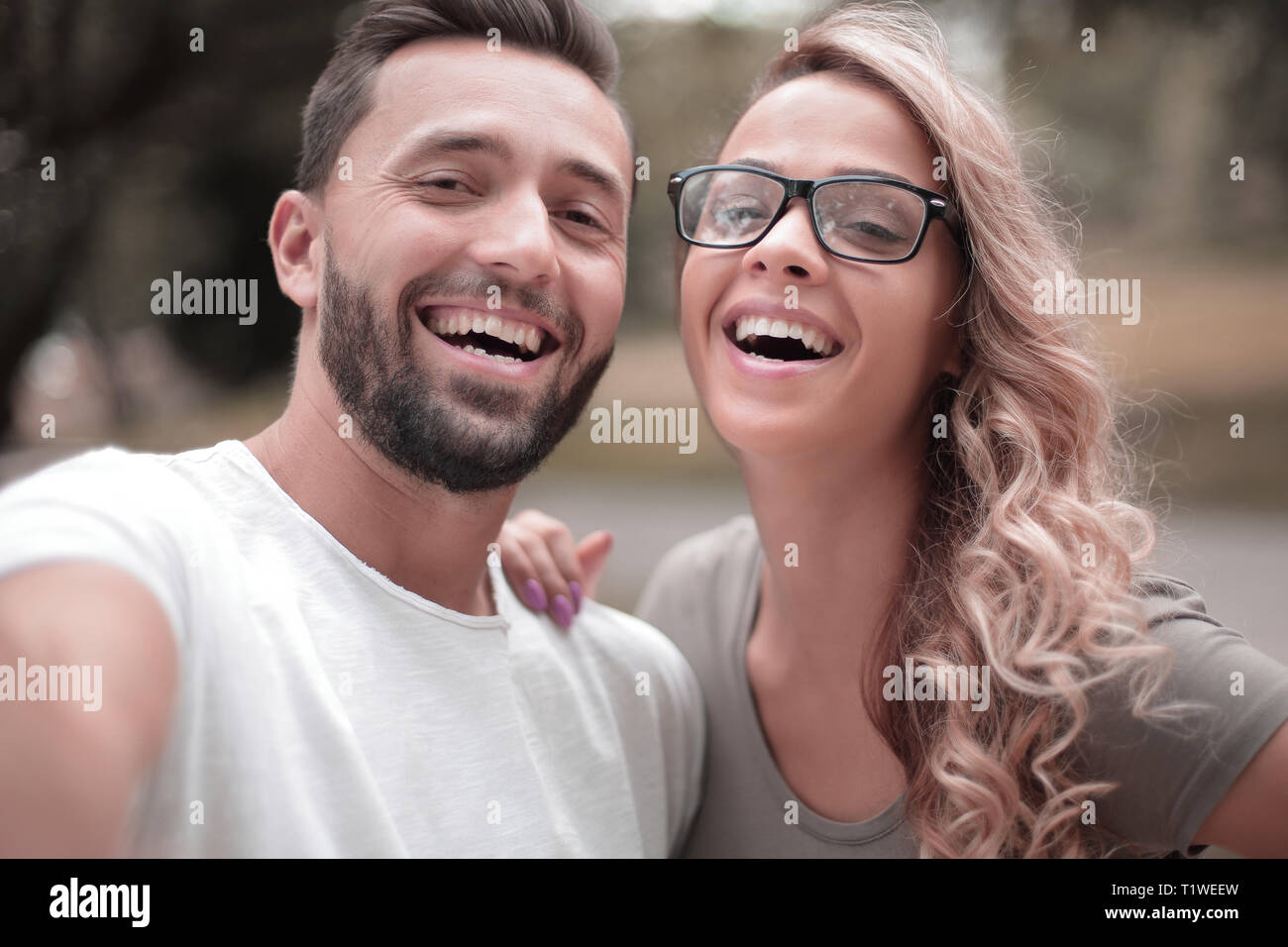smiling young couple on background of city Park Stock Photo - Alamy