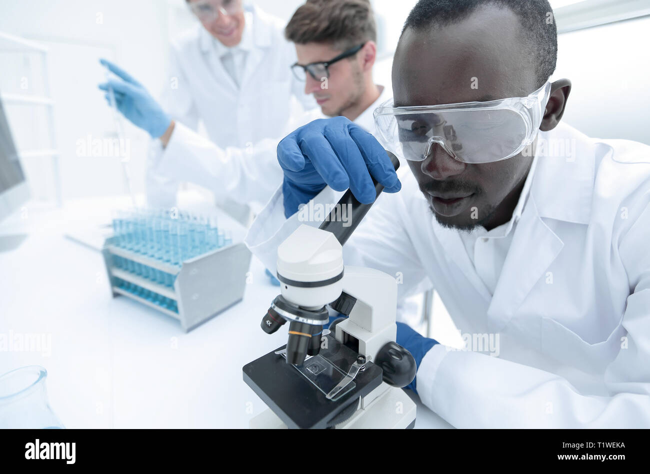 modern scientist uses a microscope in a laboratory Stock Photo - Alamy