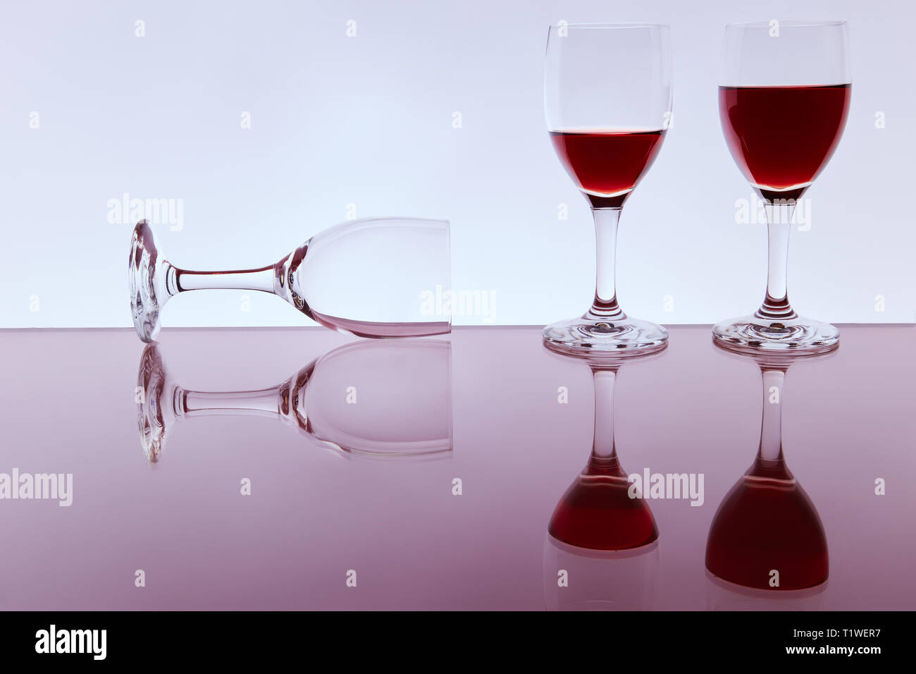 wine glasses a reflection on a light red background, backlighting Stock ...