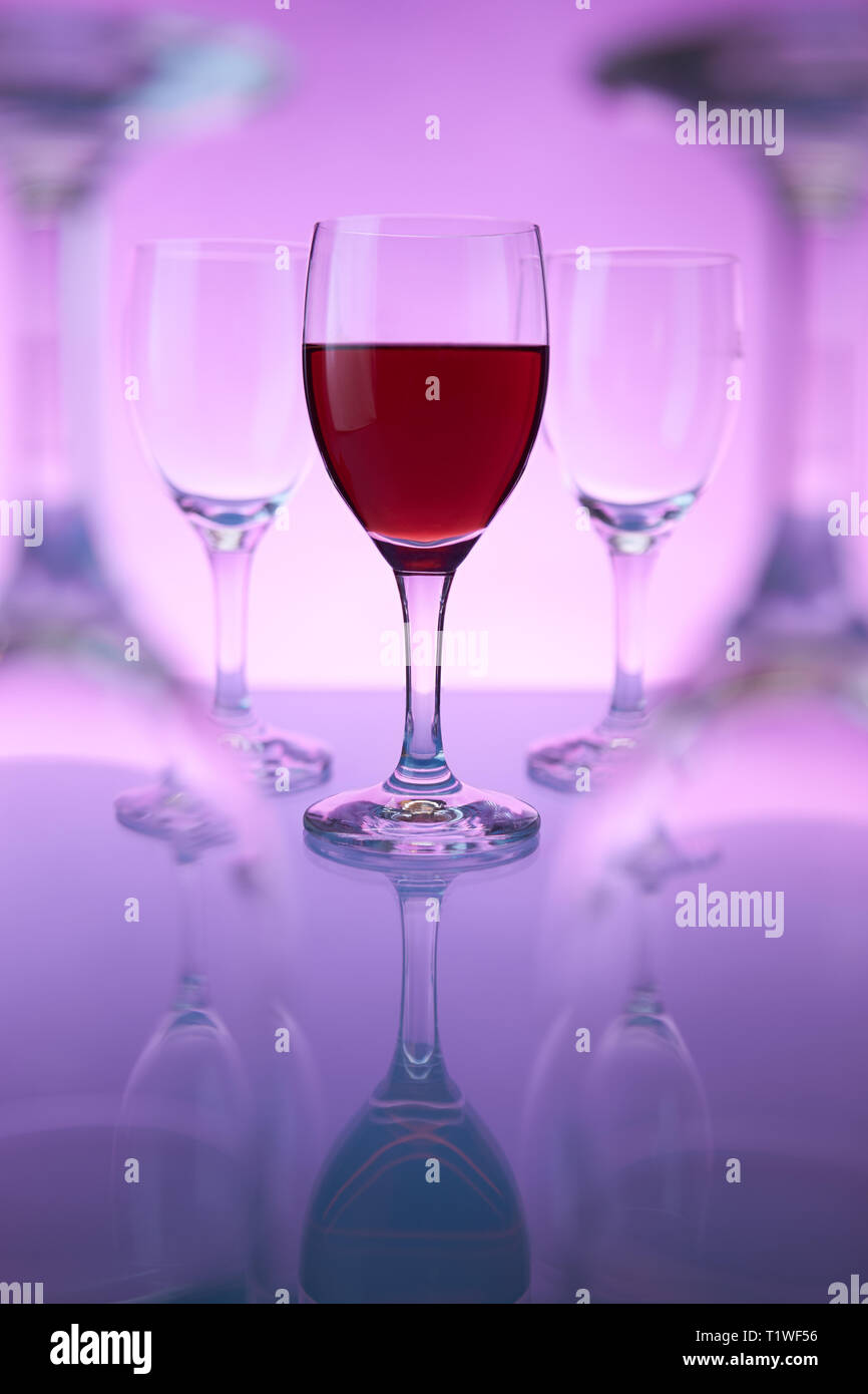 wine glasses a reflection on a light violet background, backlighting ...