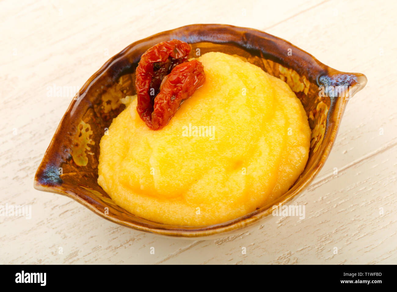 Polenta with dry tomato Stock Photo - Alamy