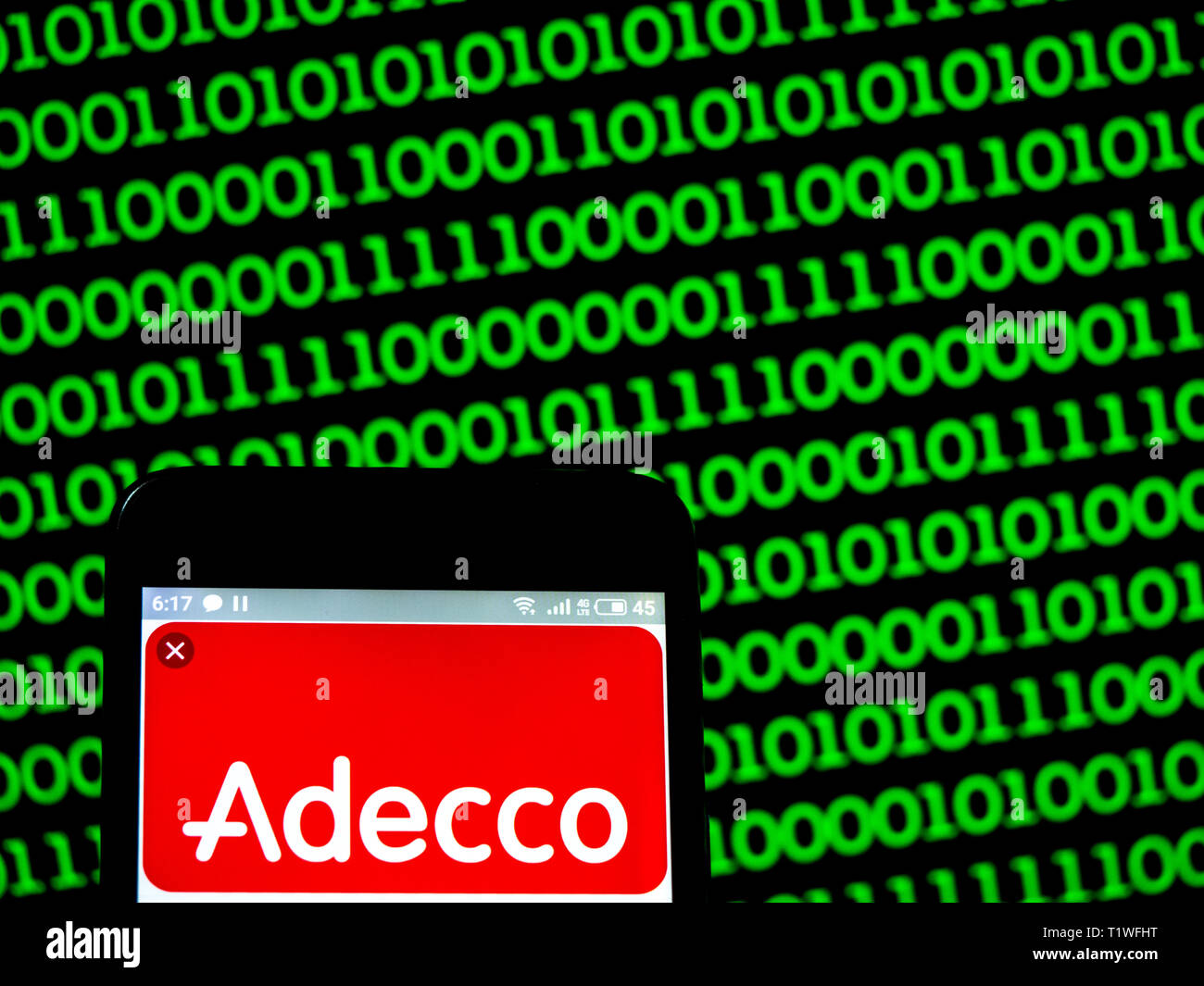 In this photo illustration The Adecco Group logo seen displayed on a ...