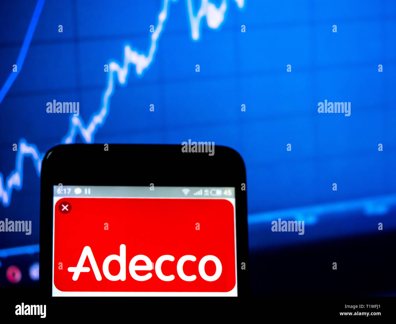 In this photo illustration The Adecco Group logo seen displayed on a ...