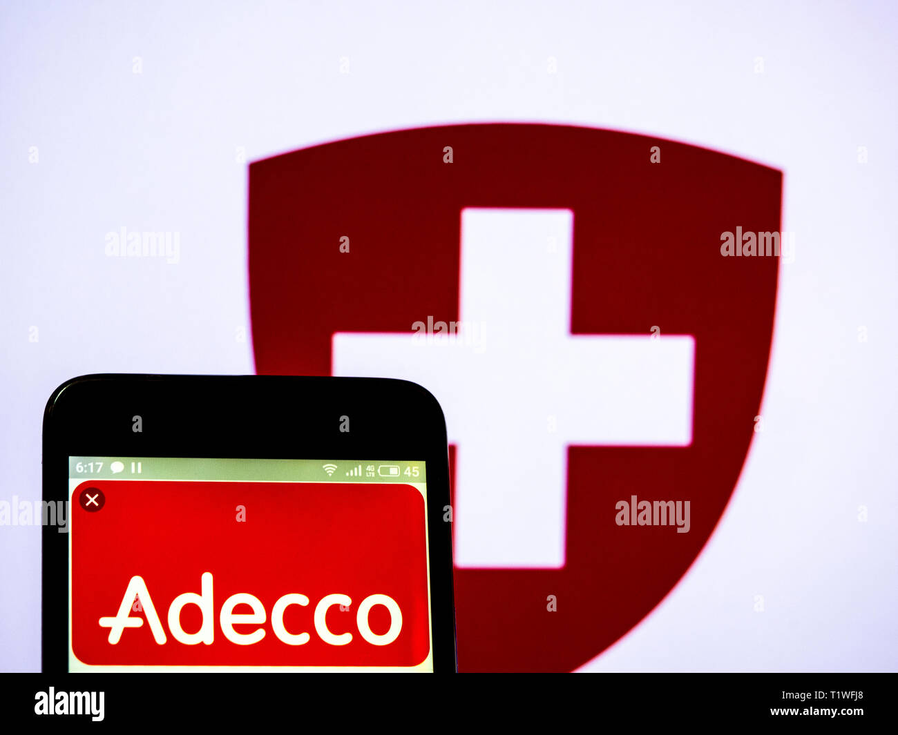 In this photo illustration The Adecco Group logo seen displayed on a ...