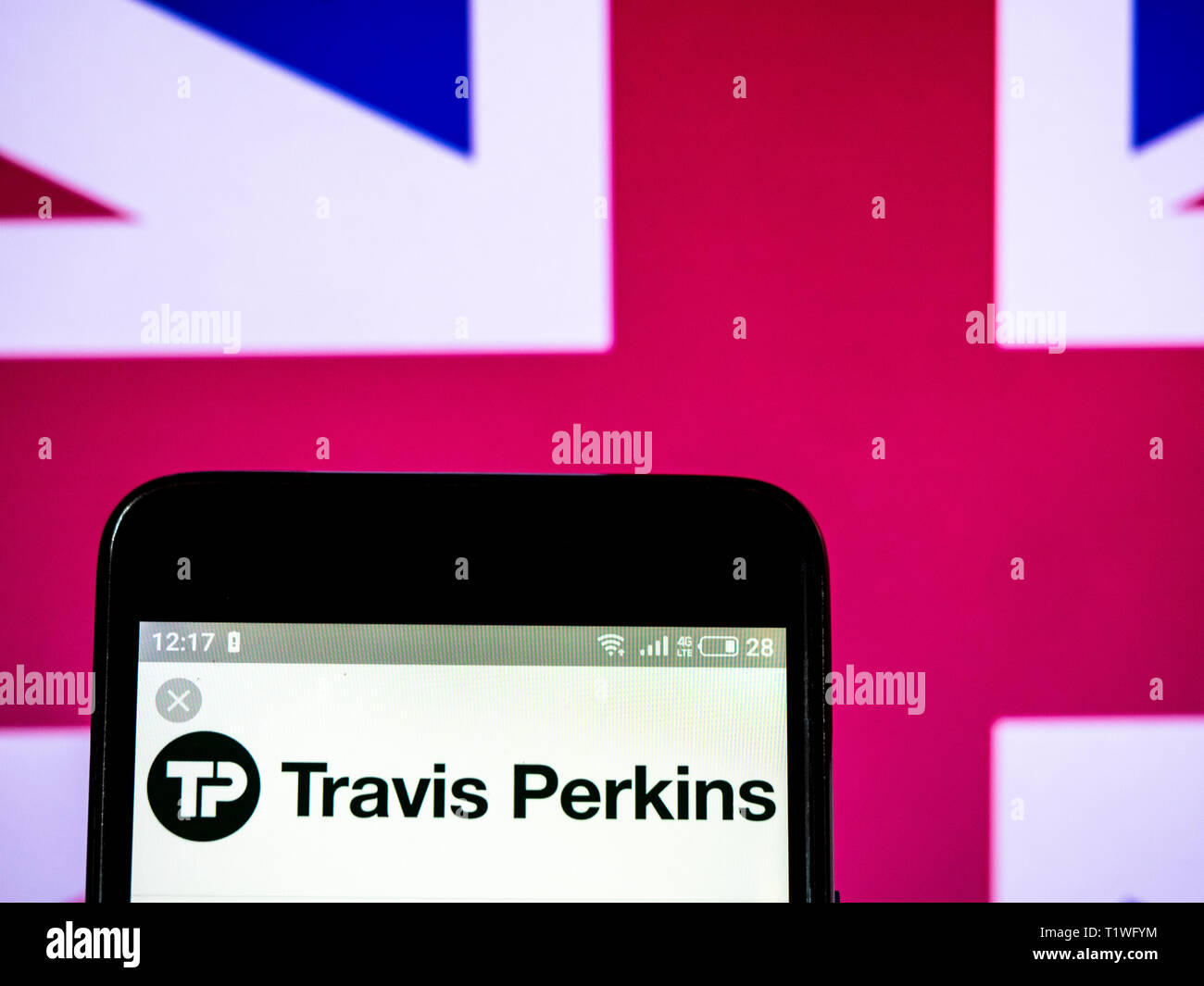 In this photo illustration a Travis Perkins plc logo seen displayed on ...