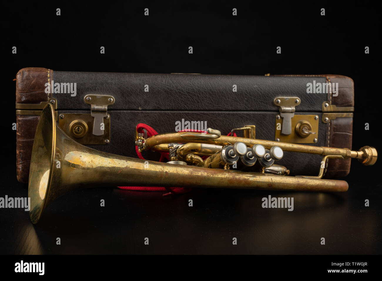 Old covered patina trumpet in a case. A historic wind musical ...