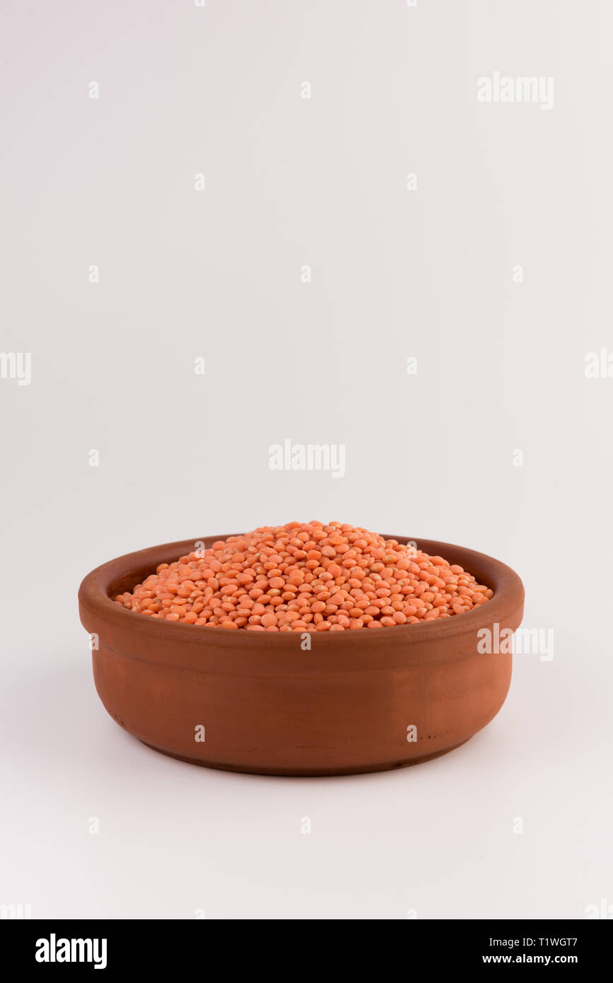 Red lentils in clay plate isolated on white background Stock Photo - Alamy