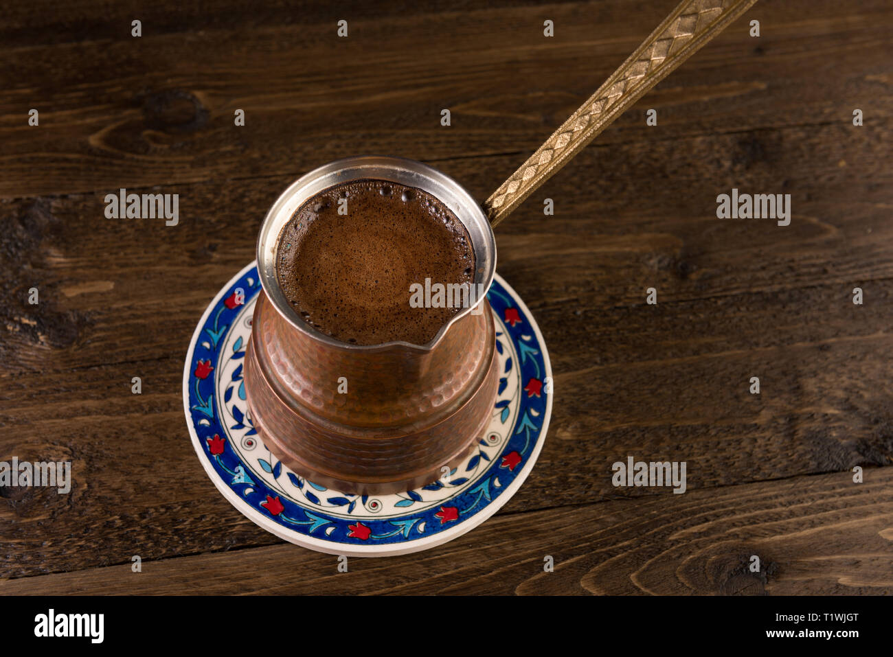 Vintage copper cezve with black coffee on wooden table Stock Photo - Alamy