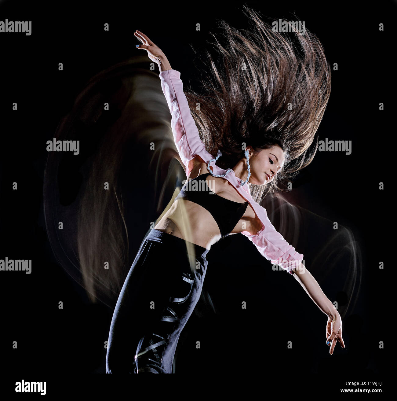 one caucasian young woman modern dancer dancing isolated on black ...
