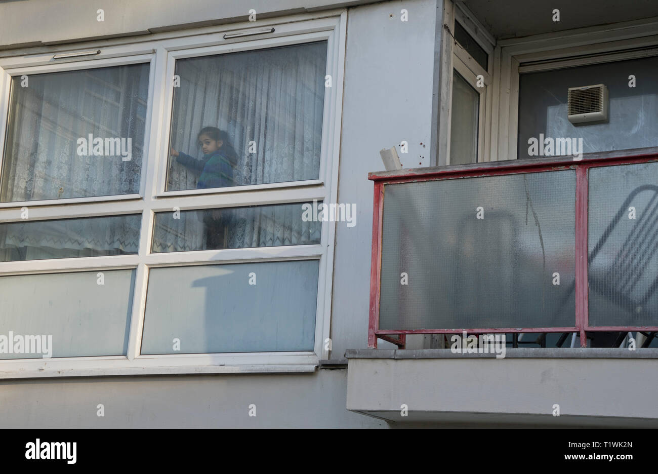 Resident child in a window in social housing council blocks in ...