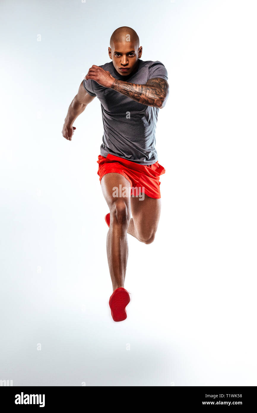 Runner wearing sportsuit demonstrating his muscles power Stock Photo ...