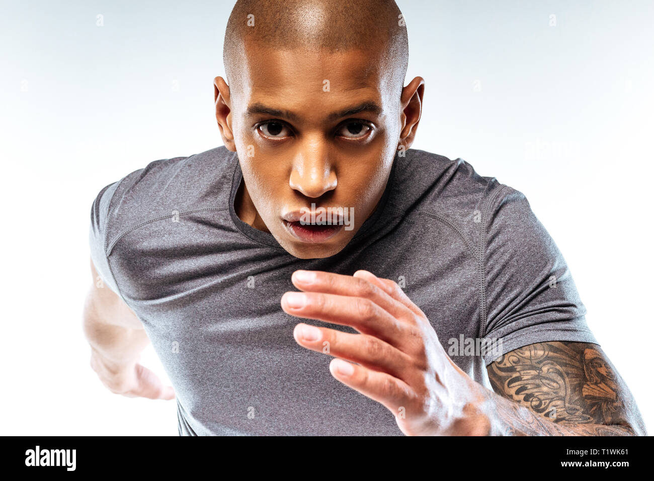 Concentrated and motivated man training running skills Stock Photo - Alamy