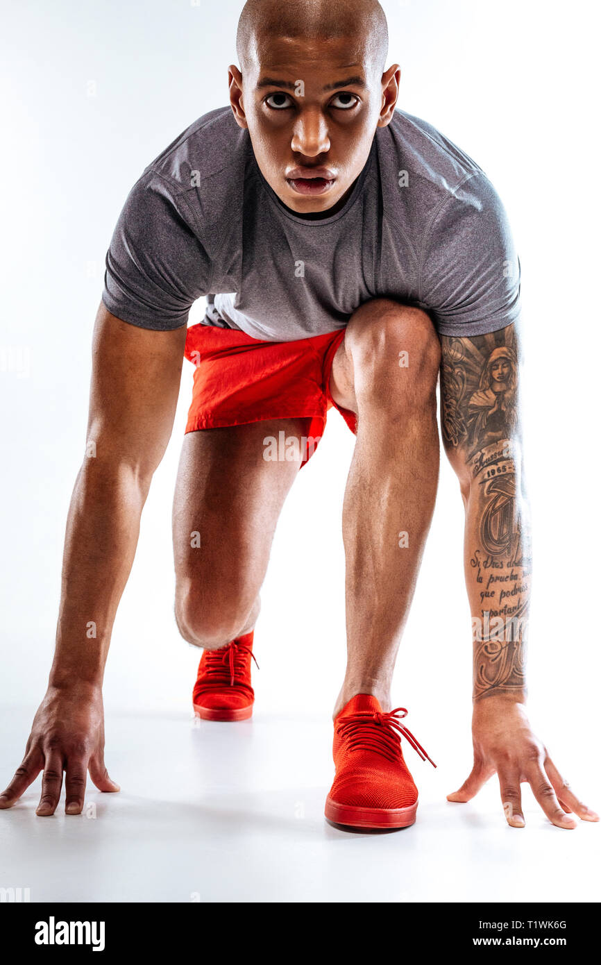 Sportive man starting to run from a low Stock Photo - Alamy