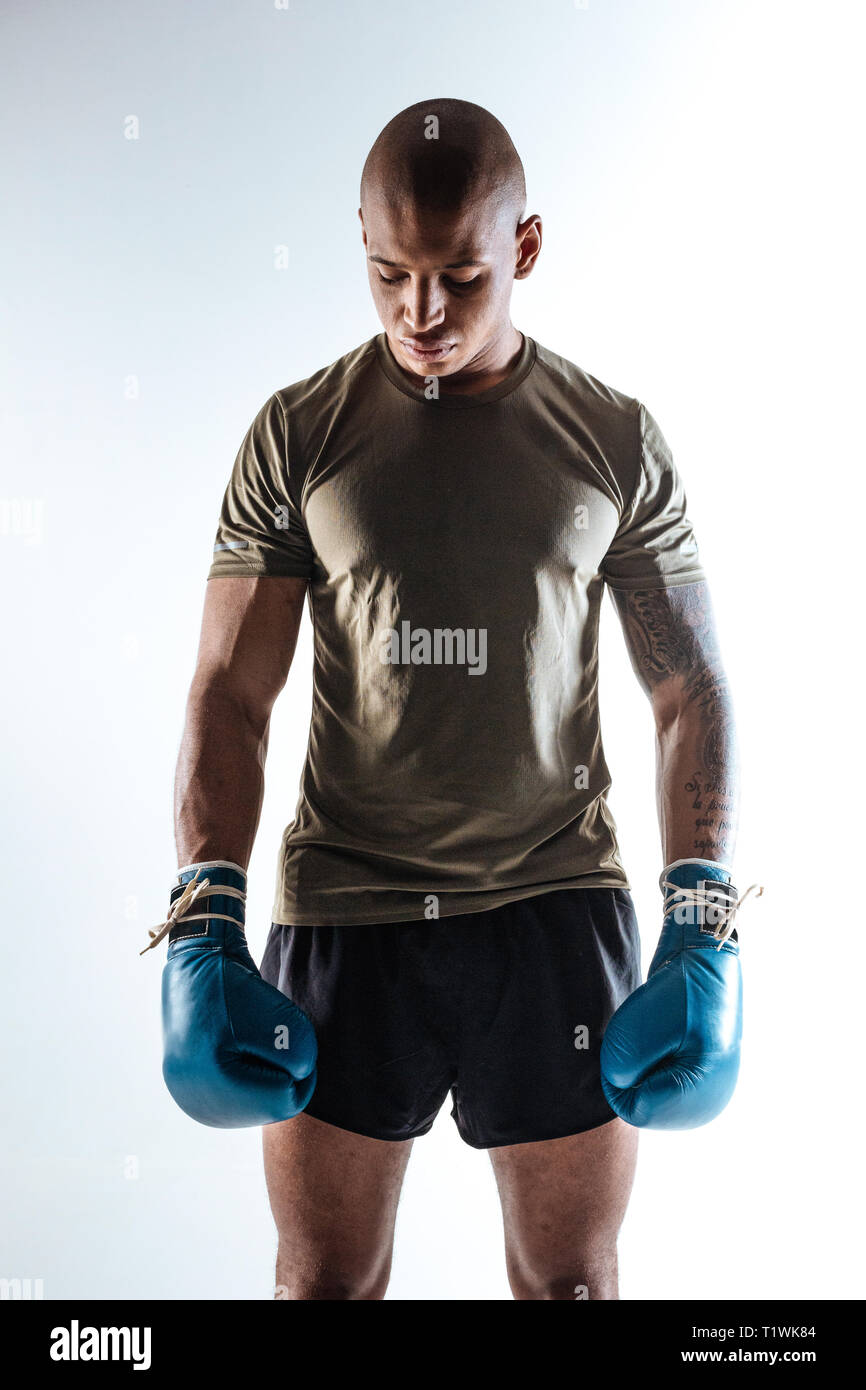 Brawny sportive boxer wearing sport suit and boxing gloves Stock Photo ...