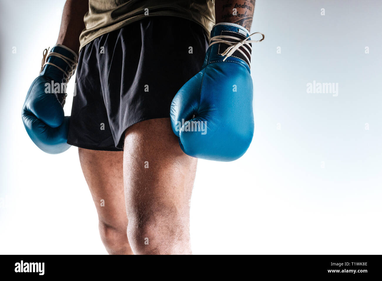 Boxers figure wearing blue boxing gloves and shorts Stock Photo - Alamy
