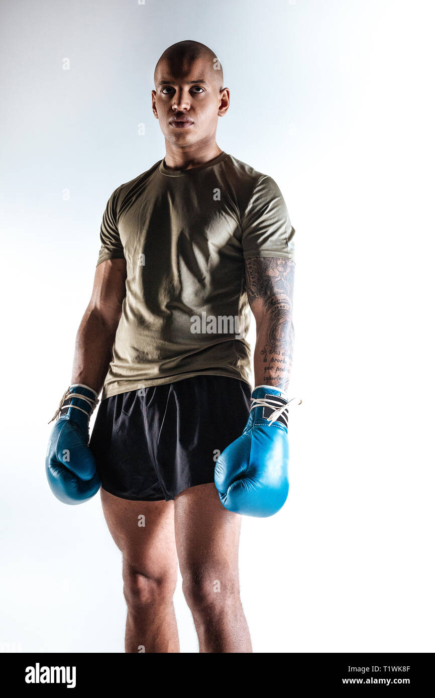 Strong young man wearing new boxing equipment Stock Photo - Alamy