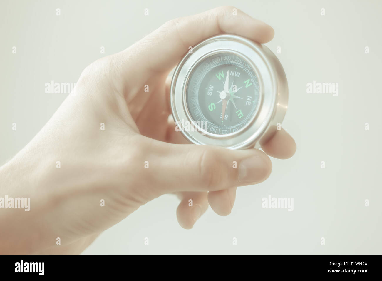 man holding a compass in his hands Stock Photo - Alamy