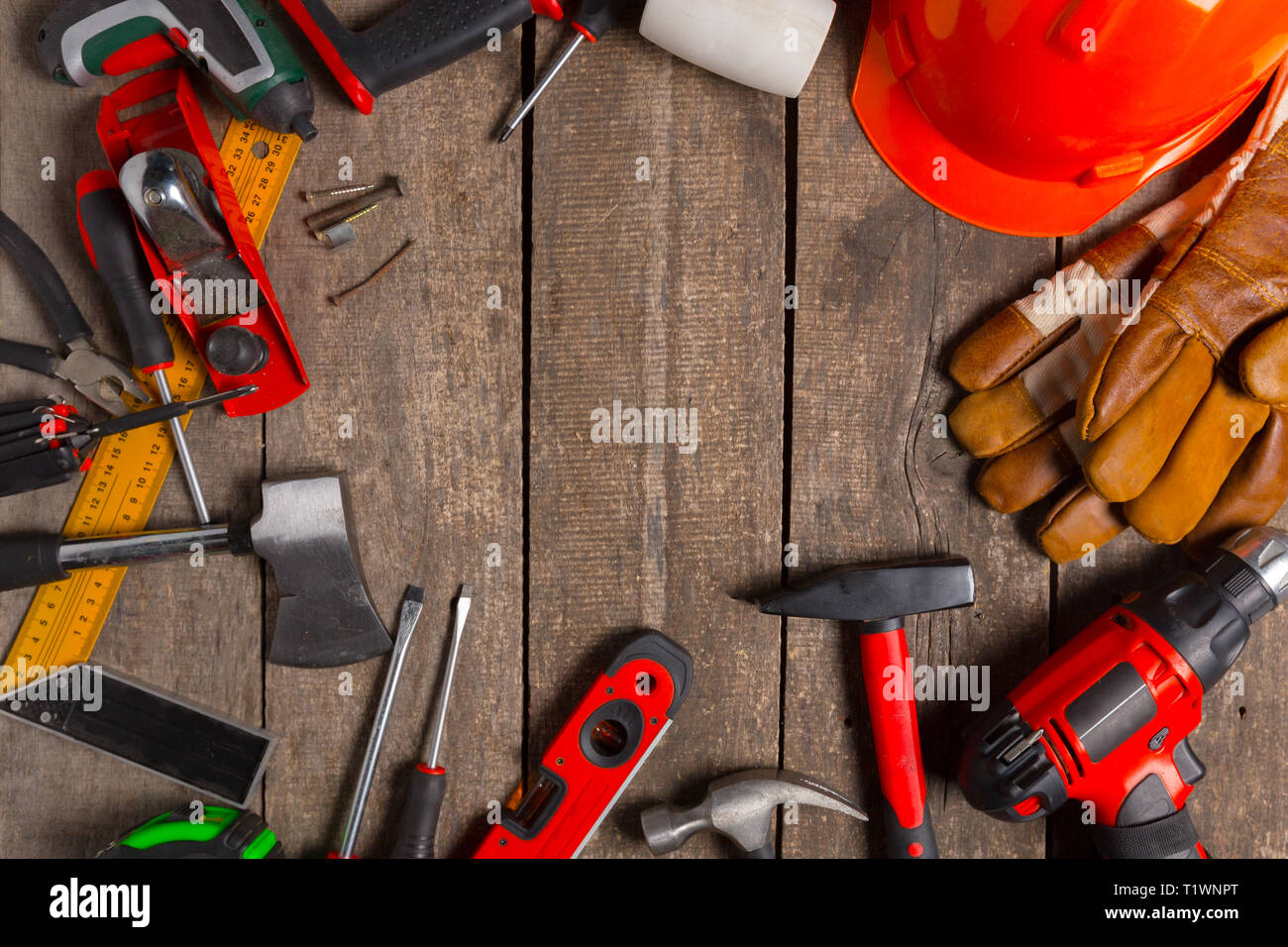 Assorted work tools on wood background Stock Photo - Alamy