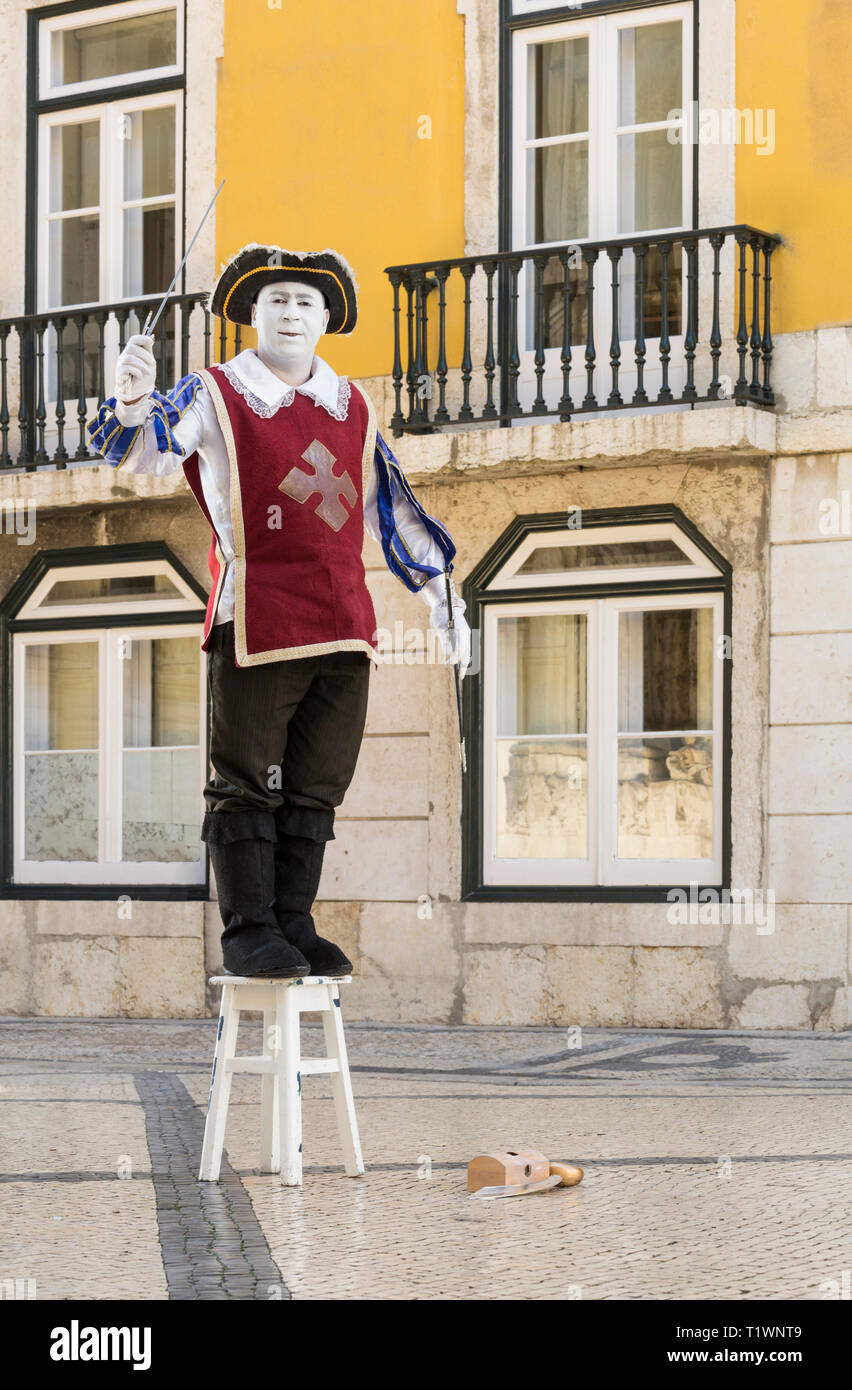 A street performer entertainer mime in traditional costume performing ...