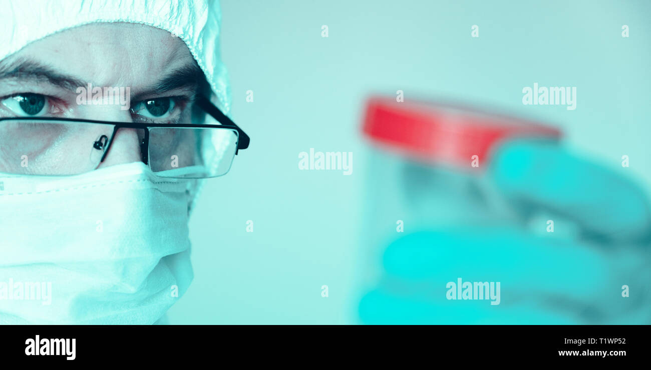 Lab technician, medic. Jar for analysis. On the face of a protective ...